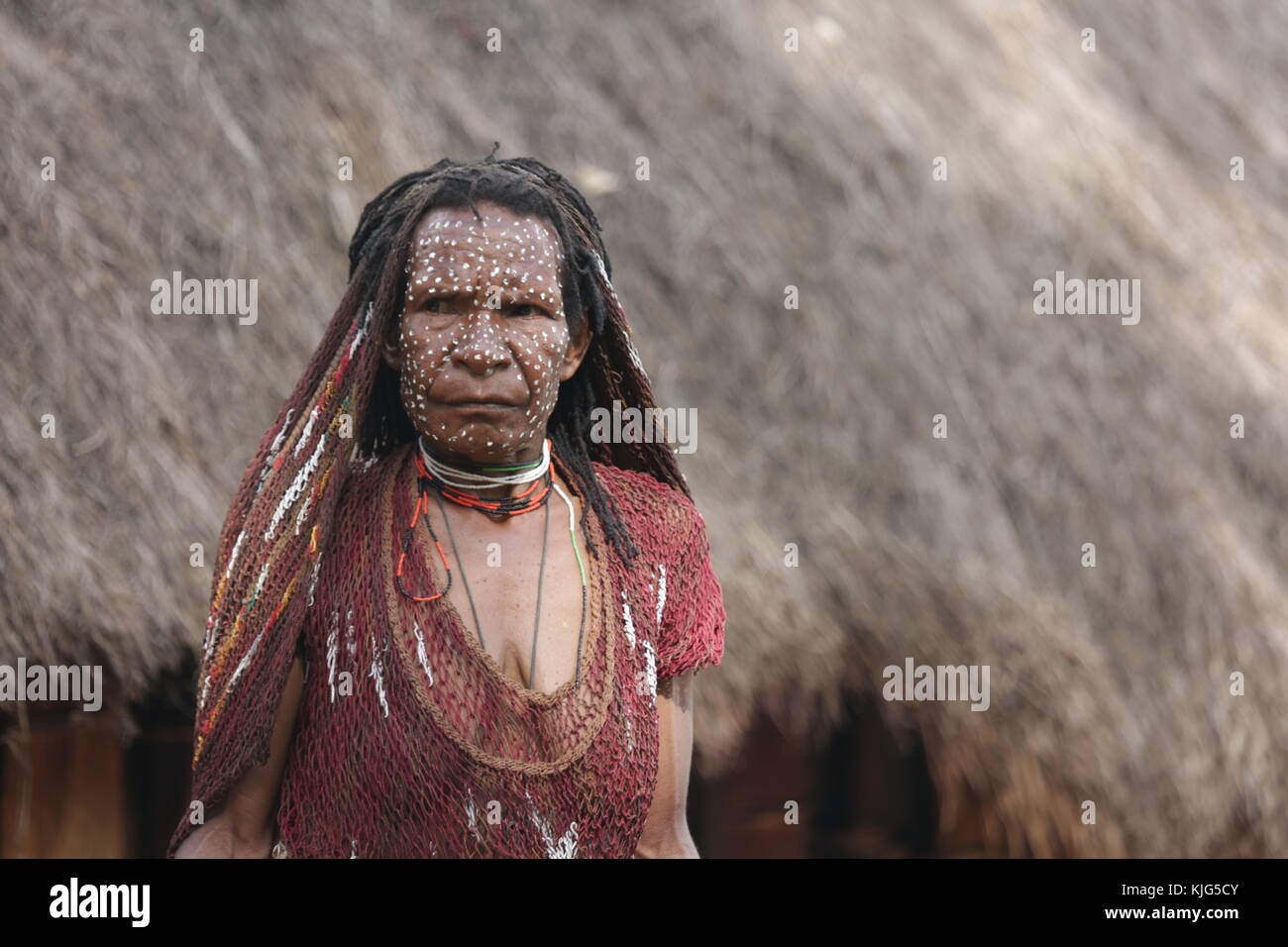 Mother of Dani Tribe weating for the others to do Rock Burning ...