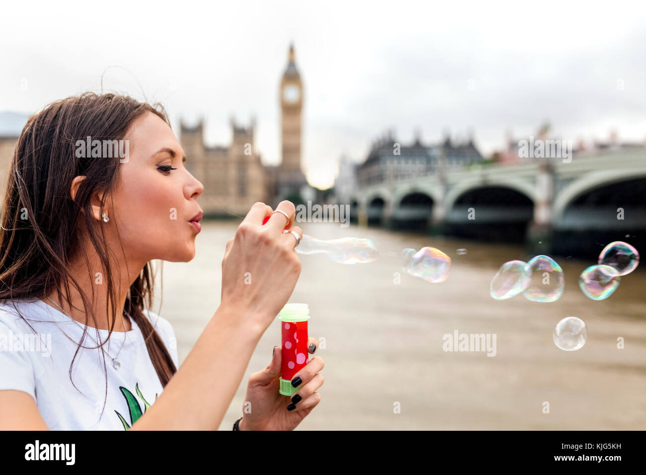 UK, London, woman making soap bubbles near Westminster Bridge Stock ...