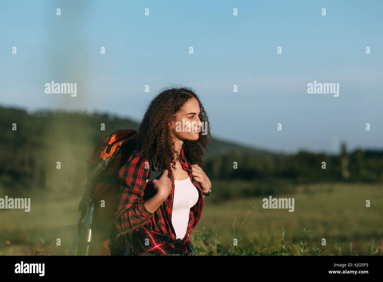 Teenage girl with backpack hiking in nature Stock Photo - Alamy