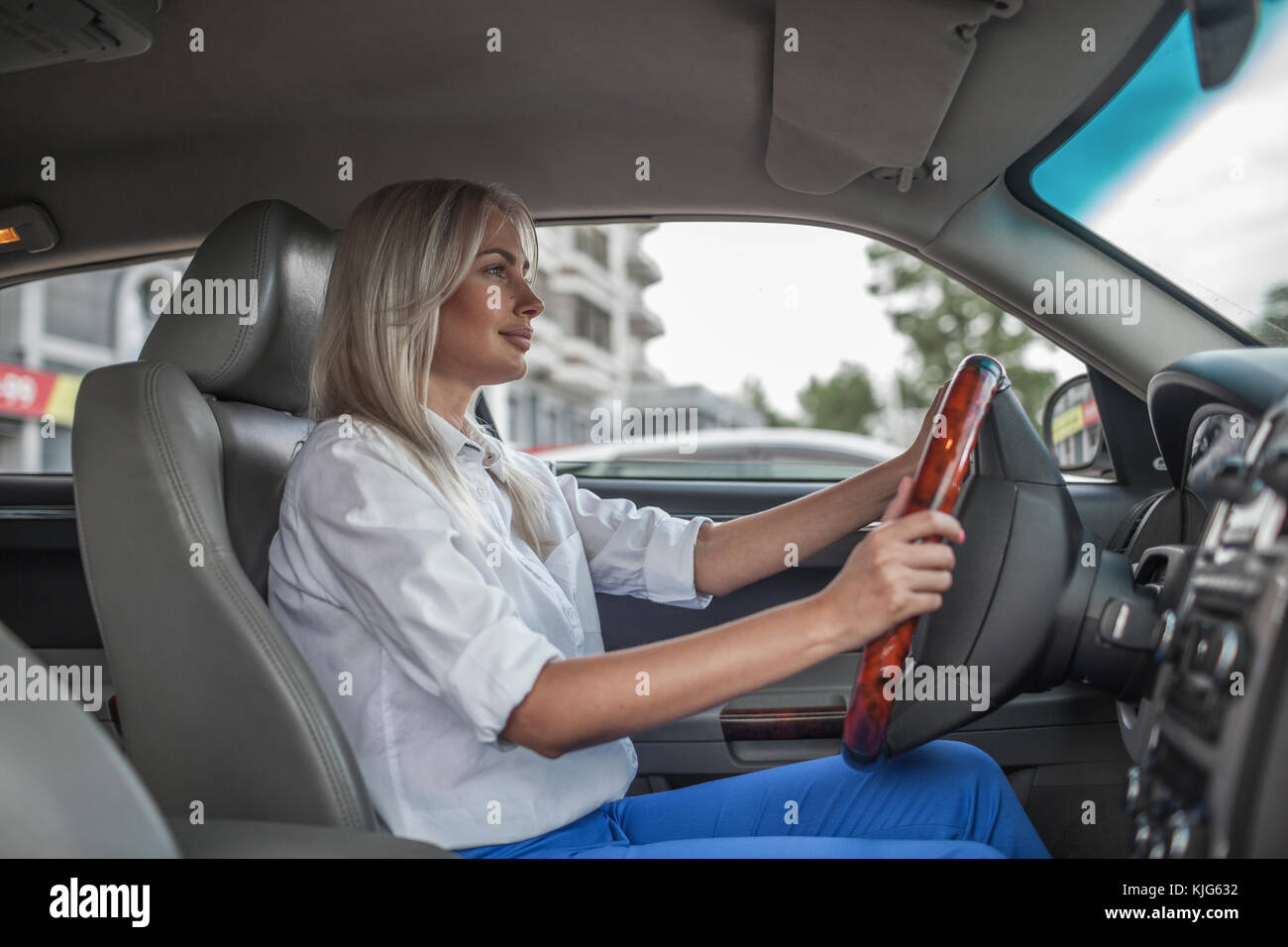 Cofident businesswoman driving car Stock Photo - Alamy