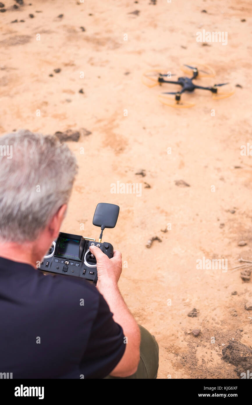 Back view of senior man with telecontrol and drone Stock Photo - Alamy