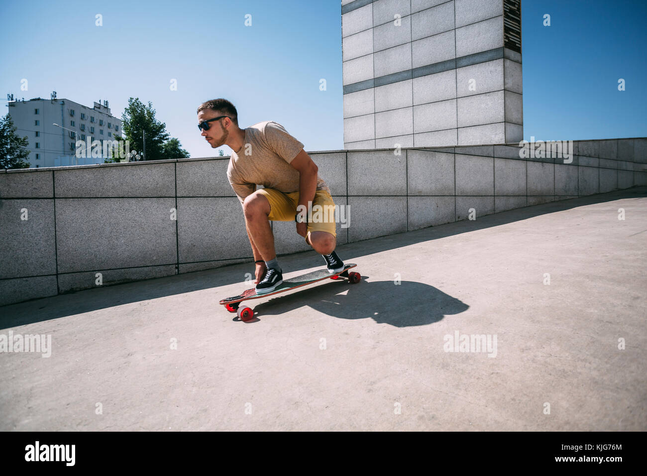 Young man riding skateboard in the city Stock Photo - Alamy