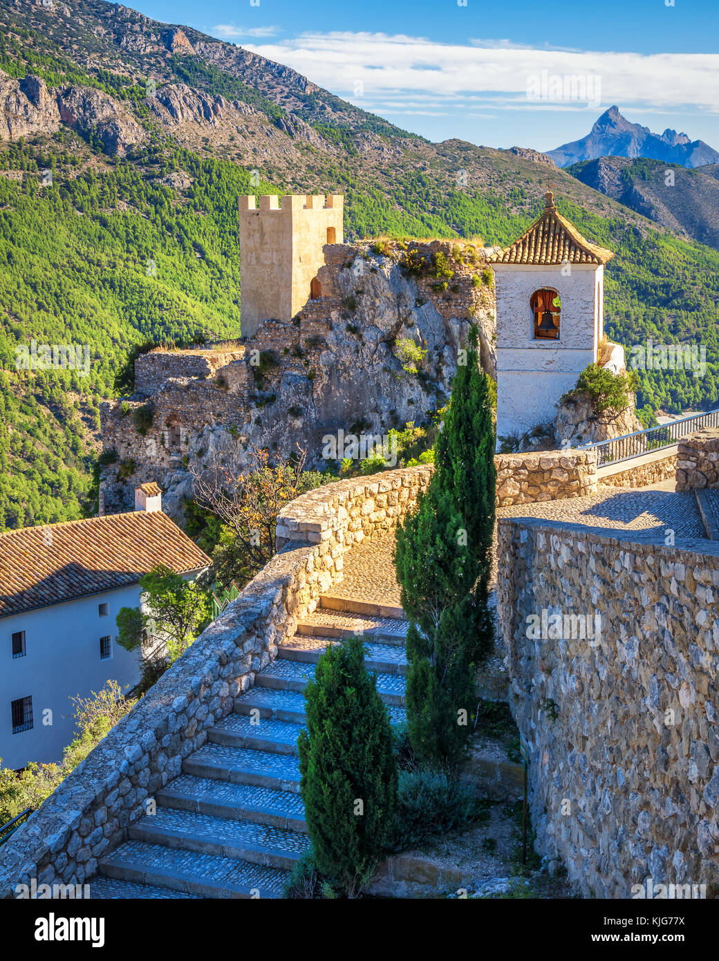 The bell tower and part of the castle at Guadalest in Spain with ...