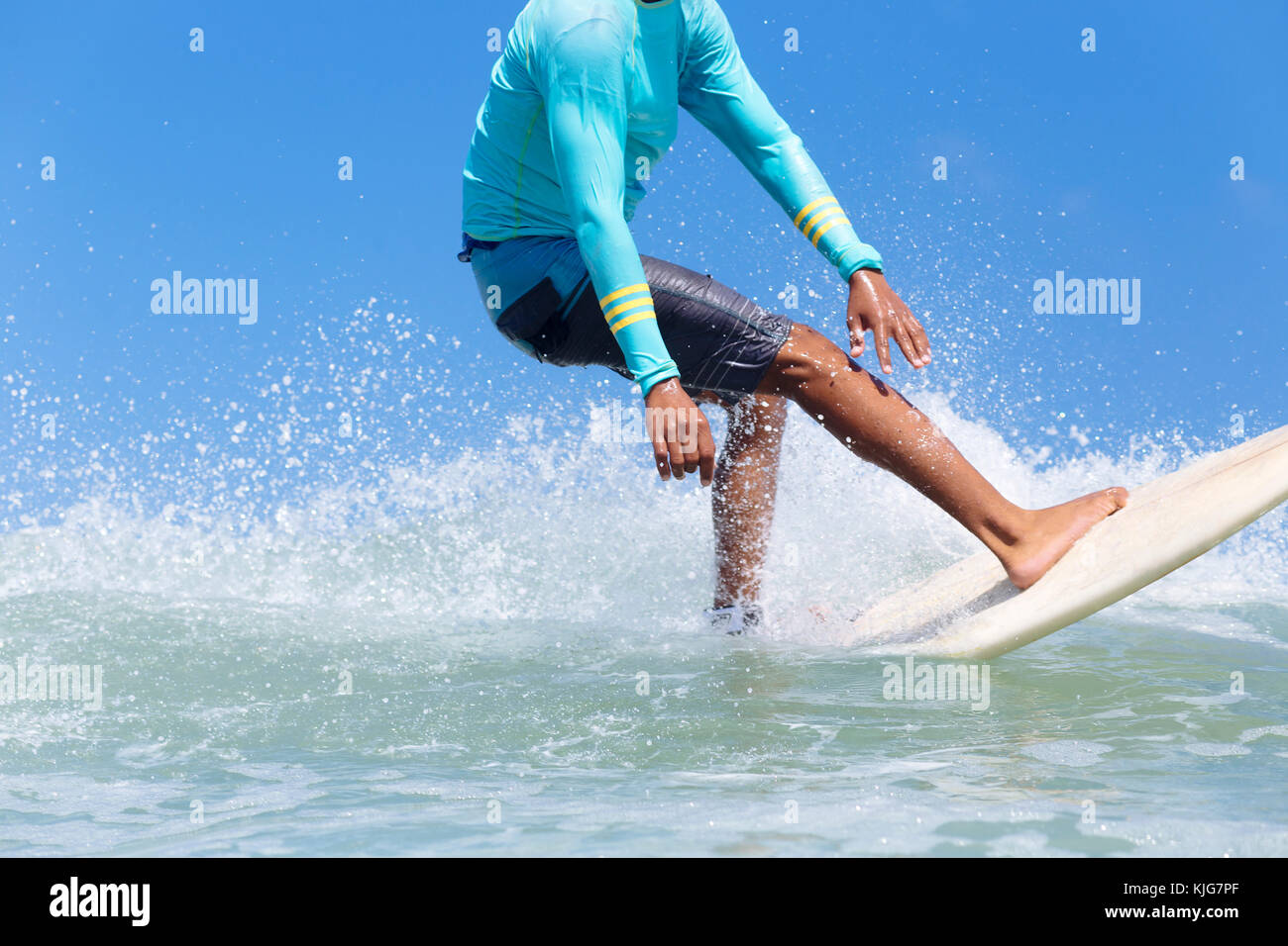 Indonesia, Bali, legs of surfer on a wave Stock Photo - Alamy