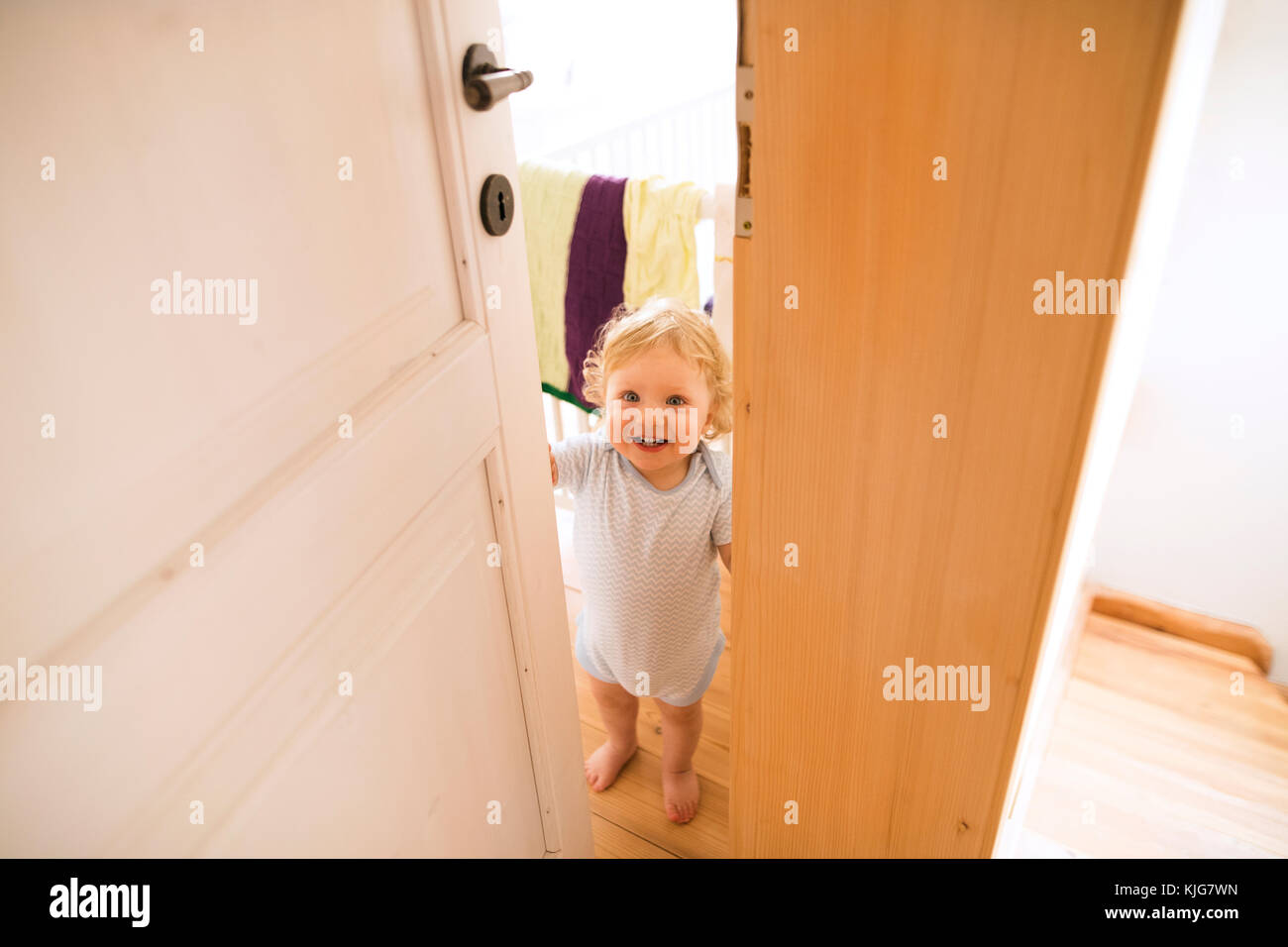 Boy opening front door hi-res stock photography and images - Alamy