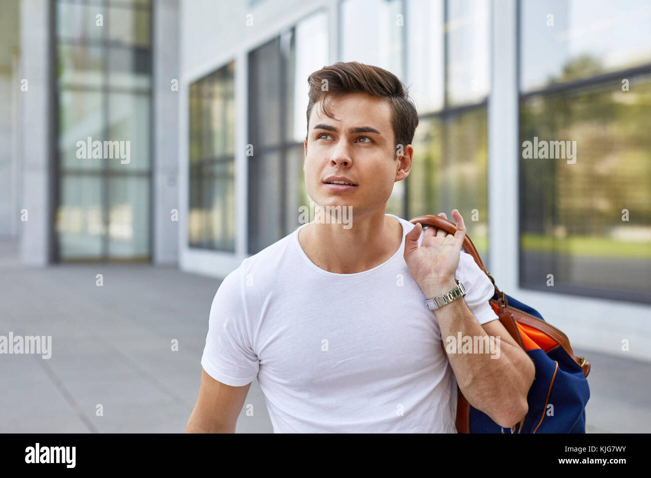 Portrait of young man with sports bag Stock Photo - Alamy
