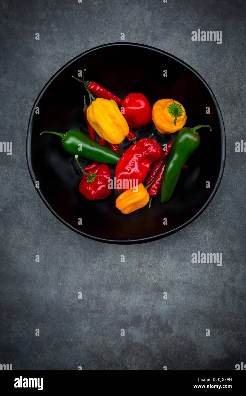 Black bowl of various chili pods Stock Photo - Alamy