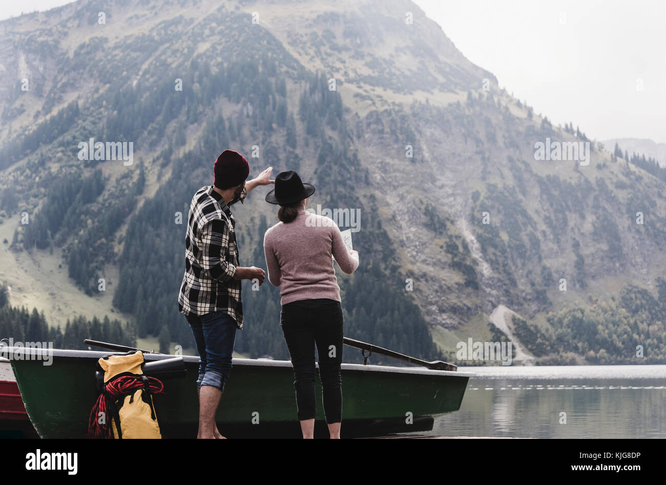 Austria, Tyrol, Alps, couple with map standing at mountain lake Stock ...