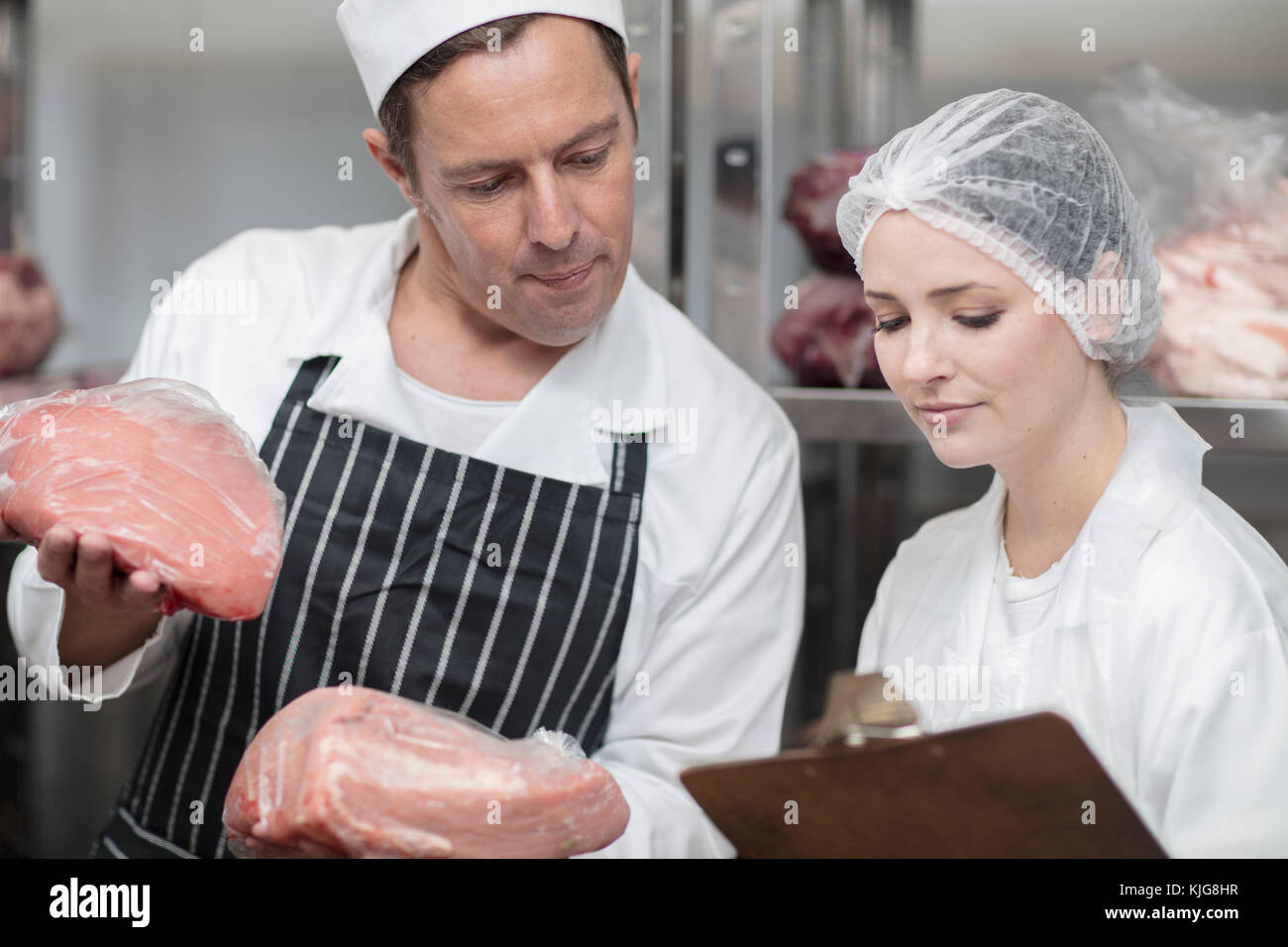 Butcher checking meat in cold room hi-res stock photography and images ...