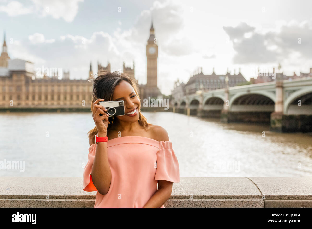 Beautiful woman taking a picture near westminster bridge hi-res stock ...