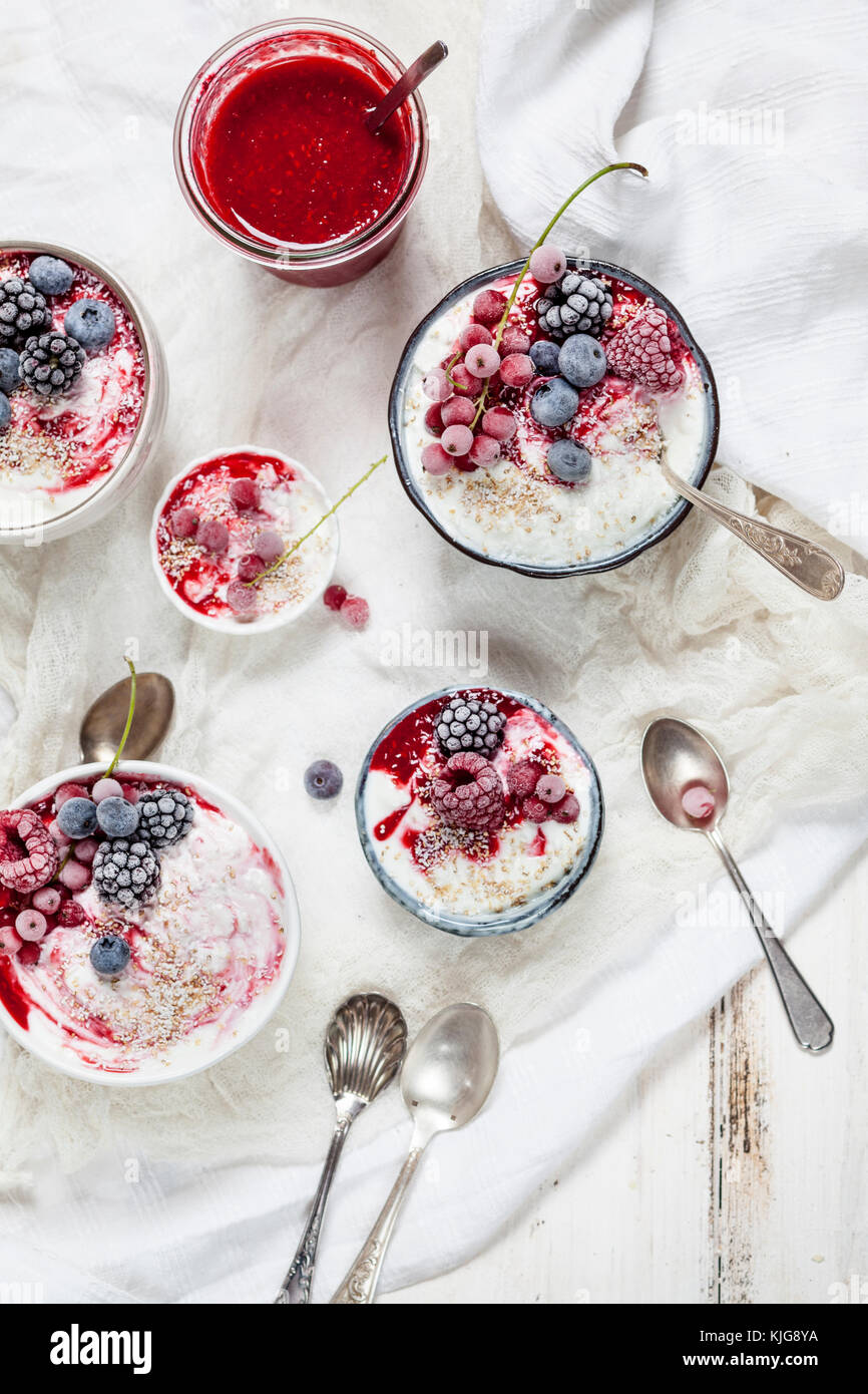 Bowl of natural yoghurt with raspberry sauce and frozen fruits Stock ...