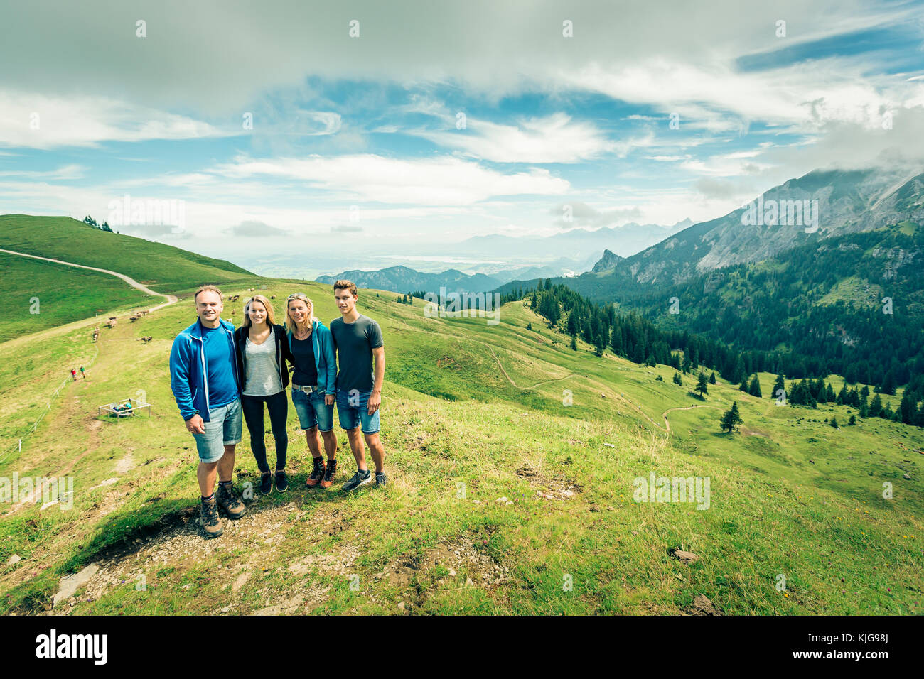Germany, Bavaria, Pfronten, portrait of happy family on alpine meadow ...