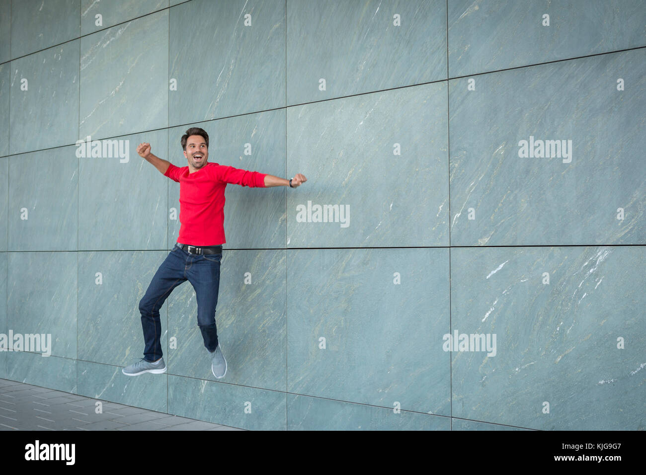 Active man jumping for joy, cheering Stock Photo - Alamy