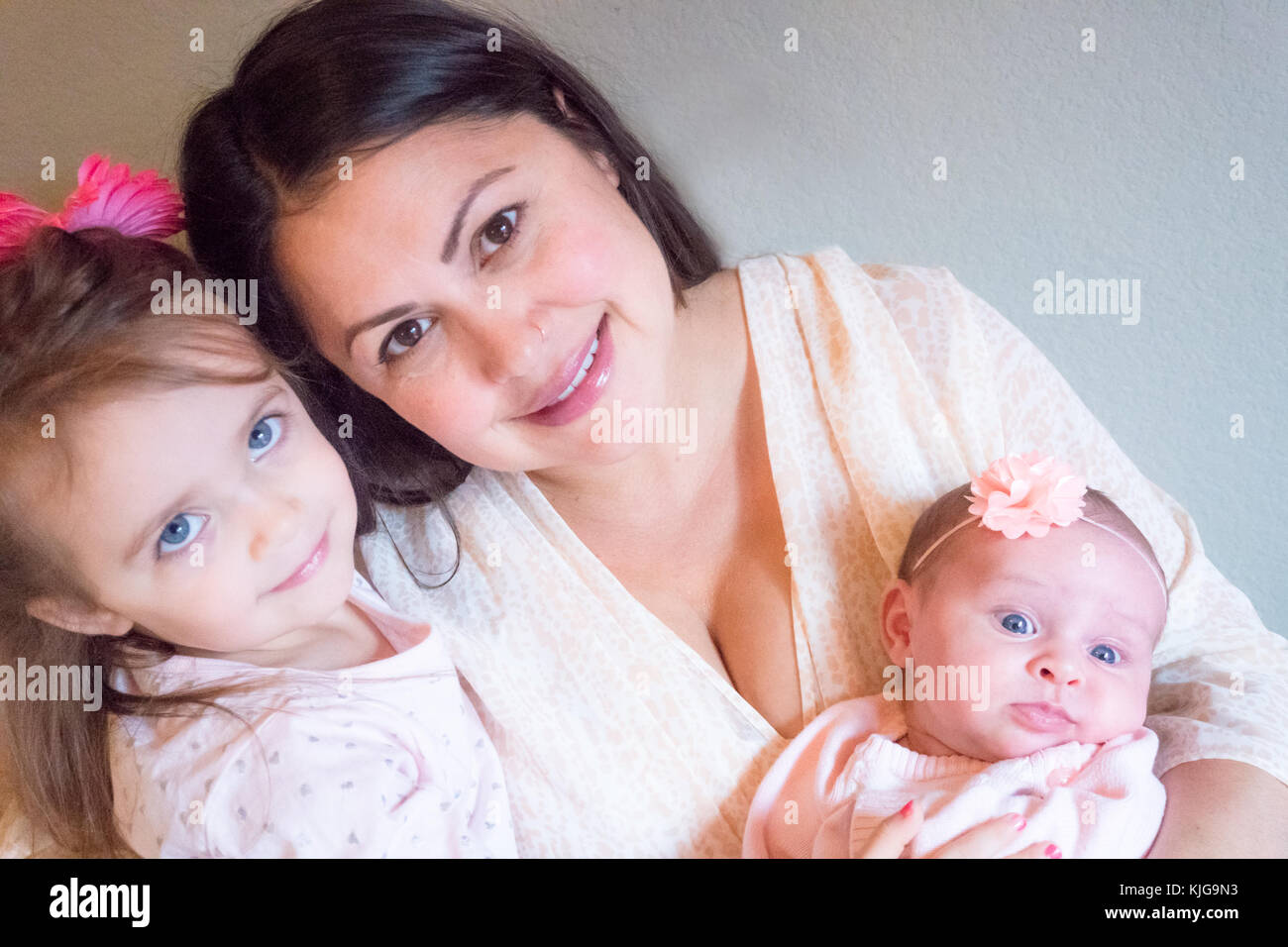 Mother with two daughters posing for lifestyle family portrait Stock ...
