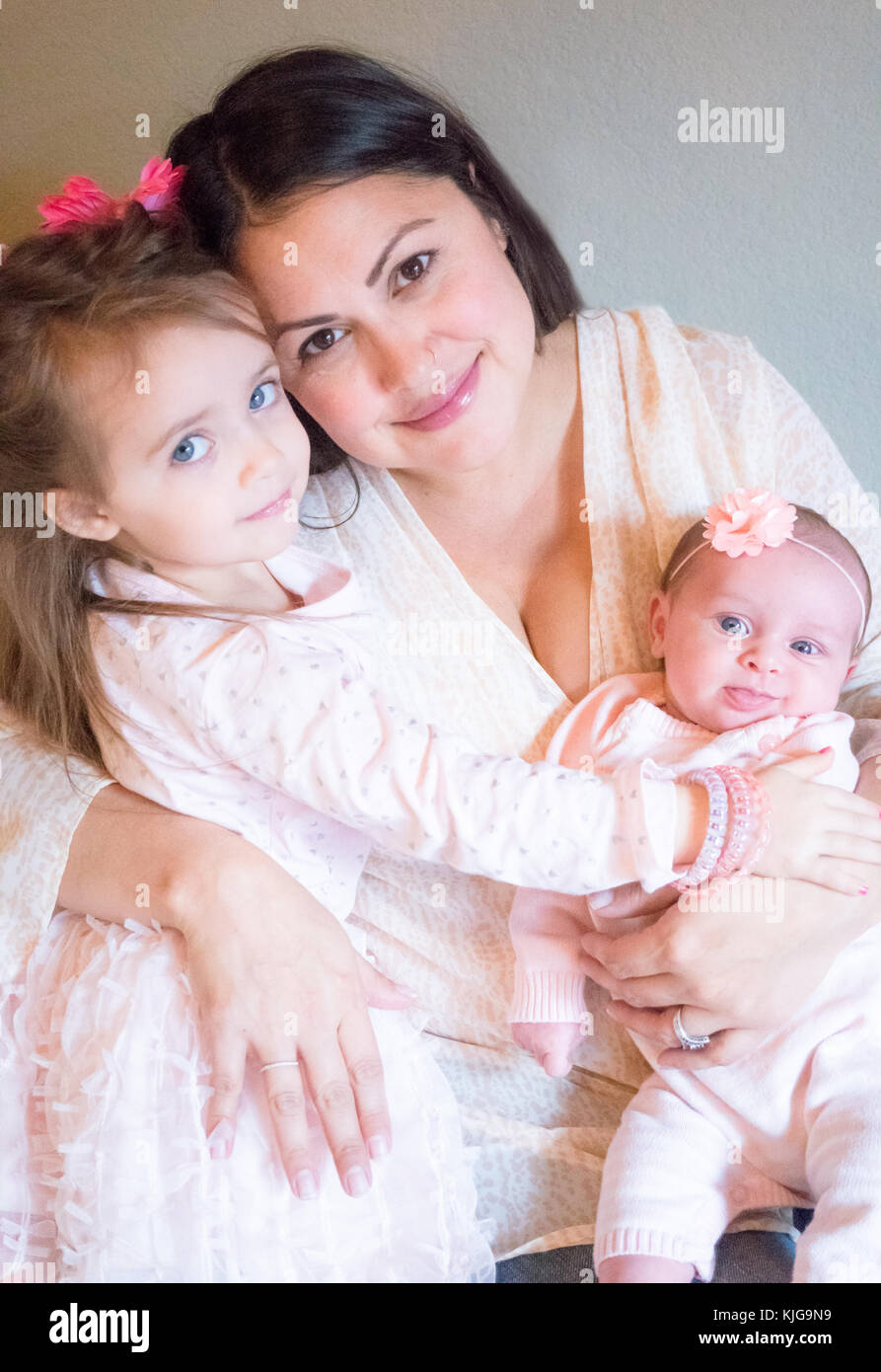 Mother with two daughters posing for lifestyle family portrait Stock ...