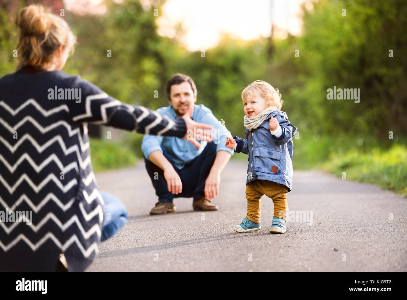 Cute little boy with parents on field path Stock Photo - Alamy