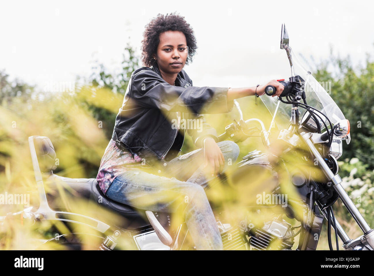 Young woman driving motorbike hi-res stock photography and images - Alamy