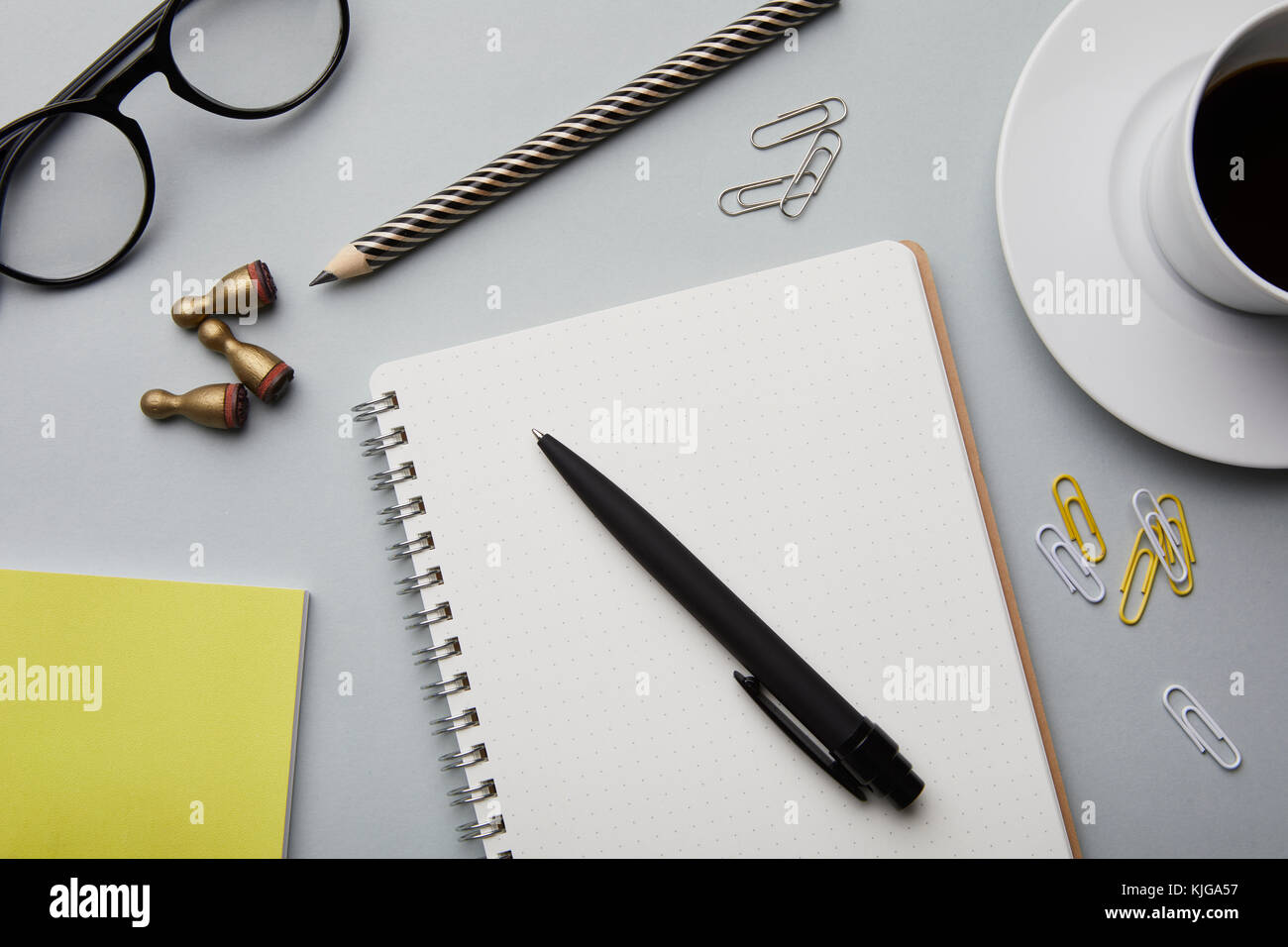 Notepad and office utensils on desk Stock Photo - Alamy
