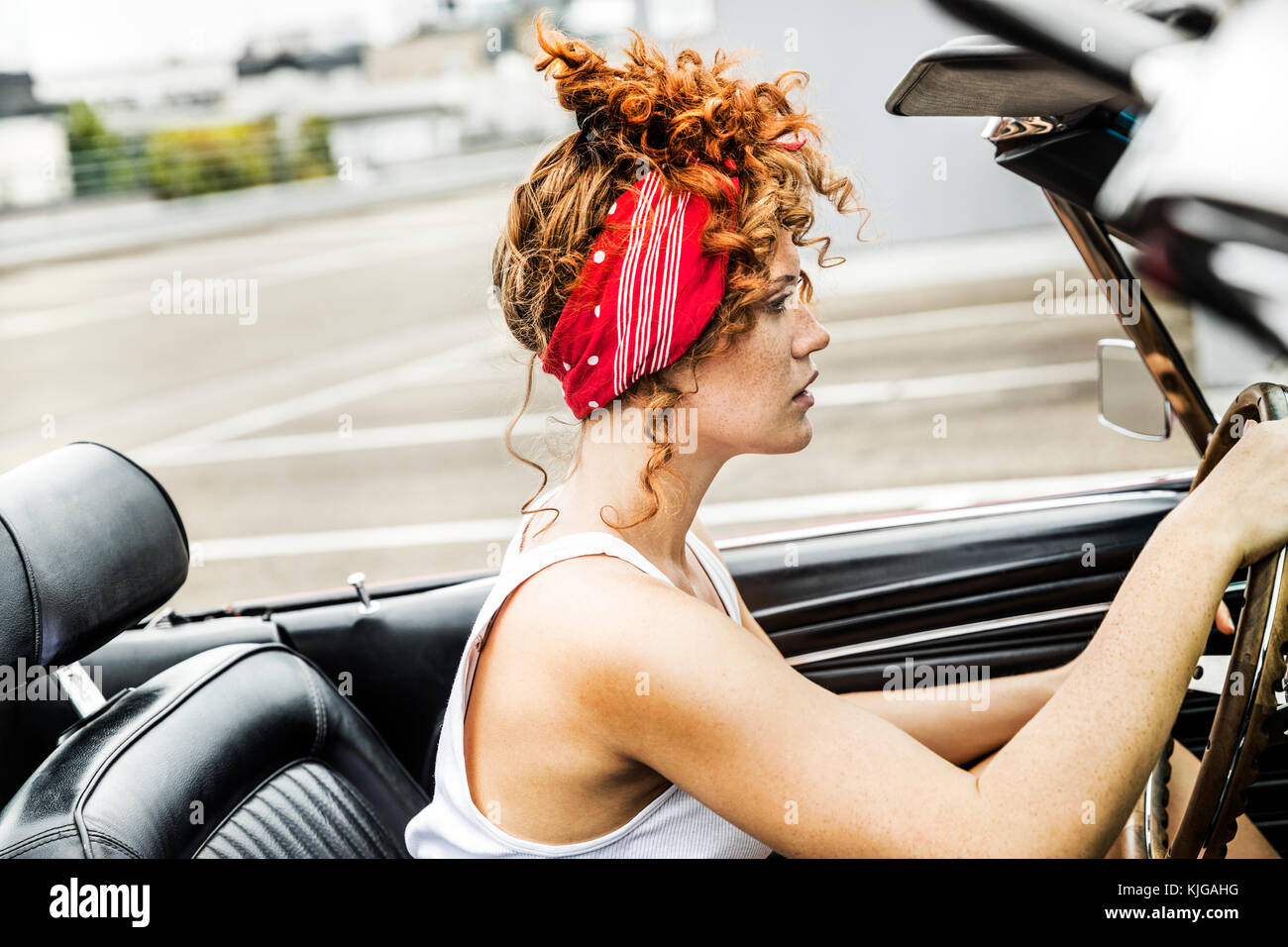 Redheaded woman in sports car Stock Photo - Alamy