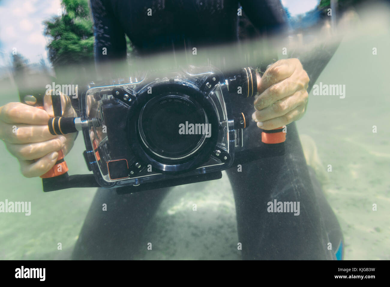 Man holding underwater DSLR camera case in a lake Stock Photo - Alamy