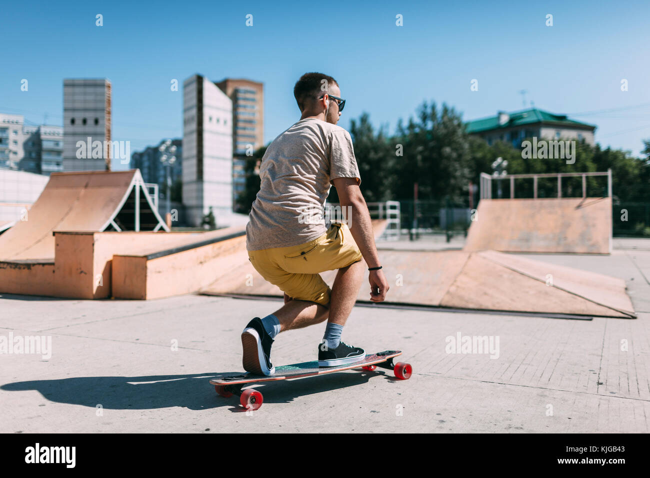 Young man riding skateboard in skatepark Stock Photo - Alamy