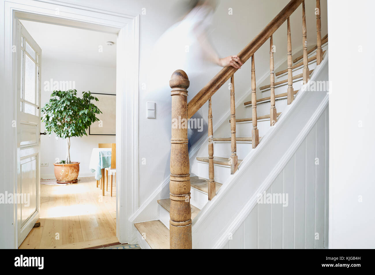 Man going upstairs on wooden stairs in an old country house Stock Photo ...