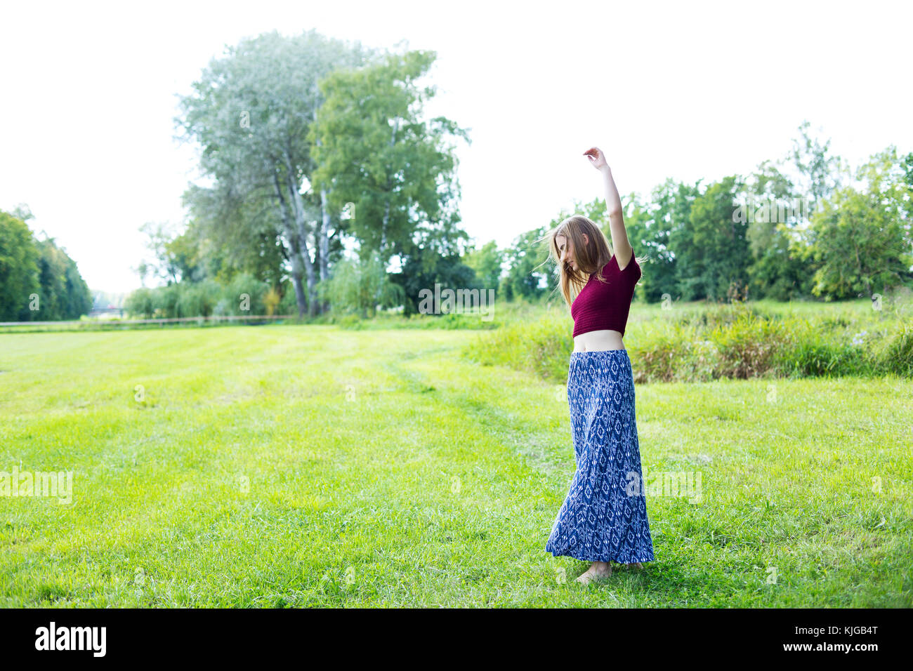 Young woman dancing on grass Stock Photo - Alamy