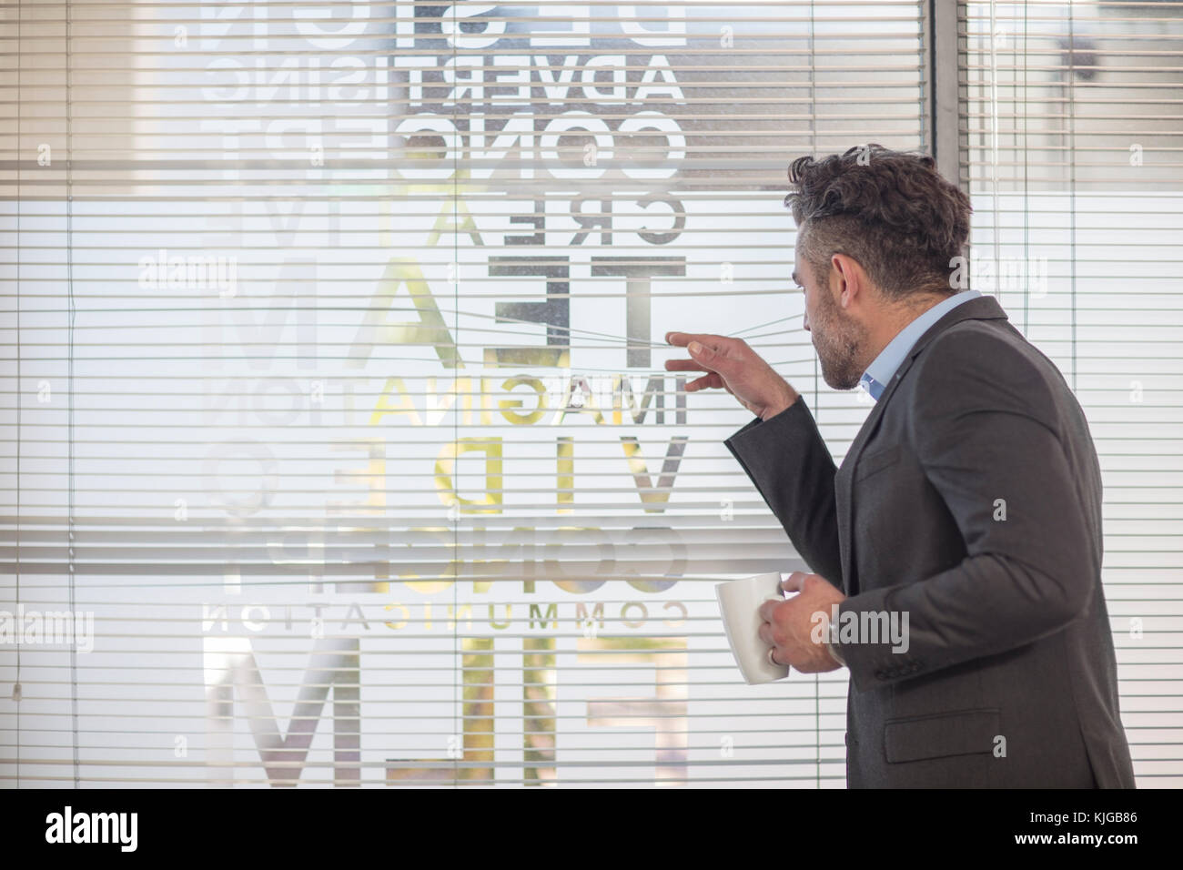Businessman looking through blinds Stock Photo - Alamy Businessman looking through blinds Stock Photo - Alamy