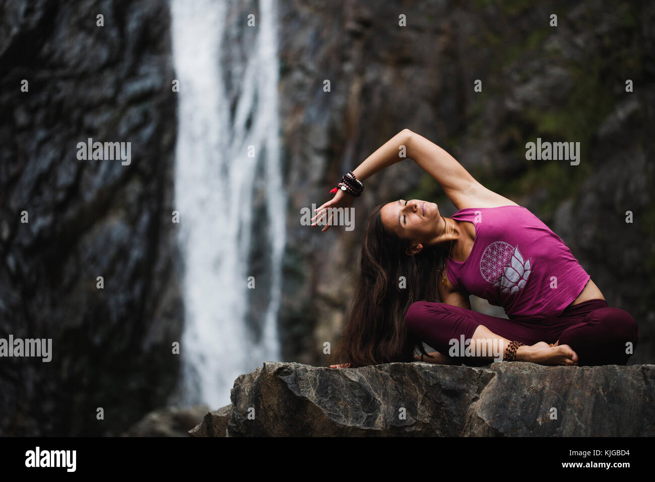Woman doing yoga practice near a waterfall hi-res stock photography and ...