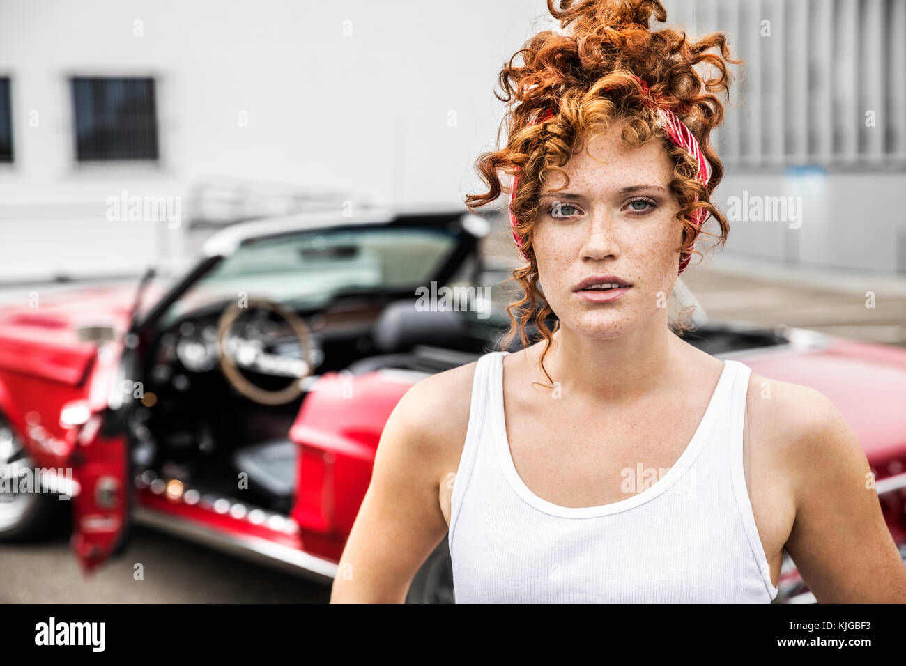Portrait of redheaded woman at sports car Stock Photo - Alamy