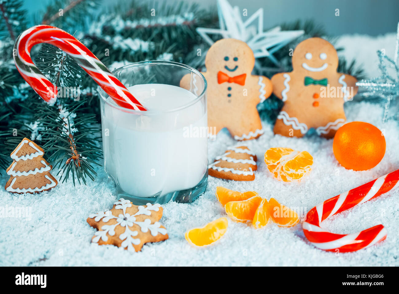 Christmas gingerbread and milk with decorations, snow, christmas tree ...