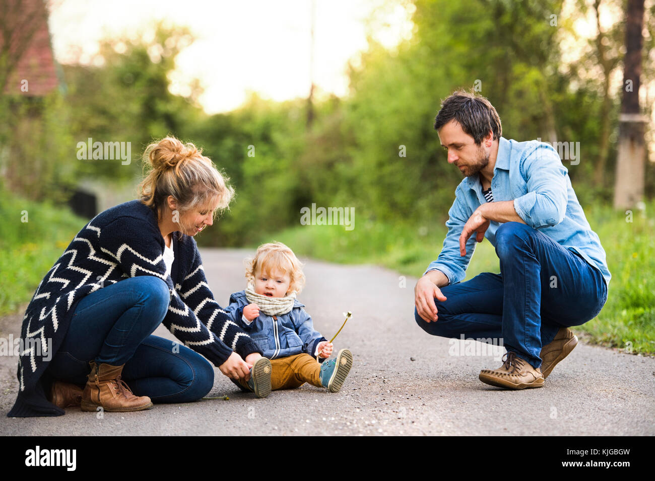 Cute little boy with parents on field path Stock Photo - Alamy