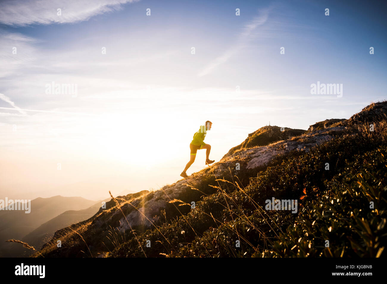 Italy, man running on mountain trail Stock Photo - Alamy