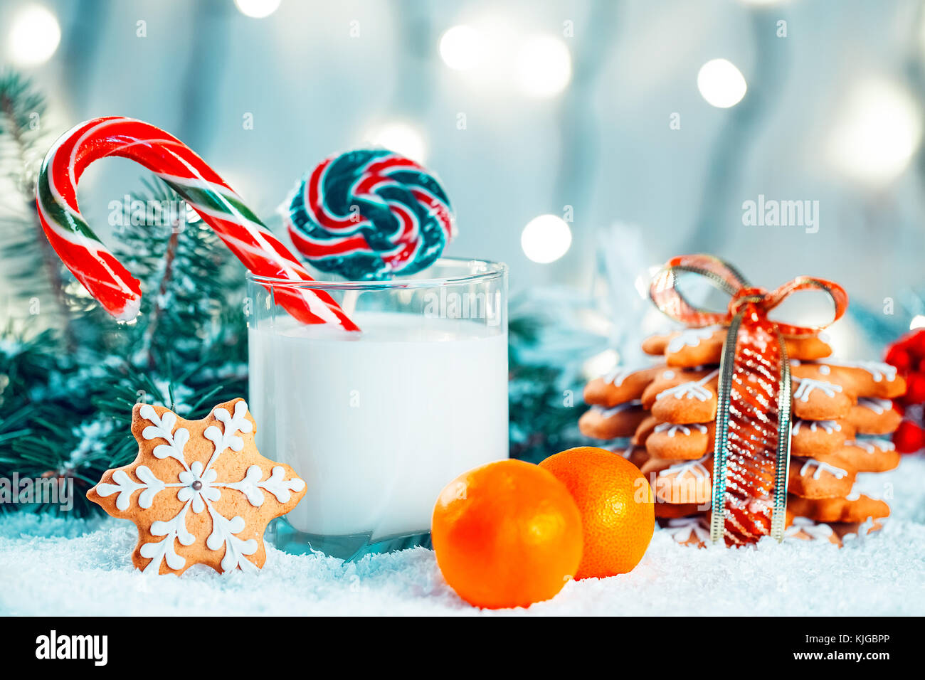 Christmas gingerbread and milk with decorations, snow, christmas tree ...