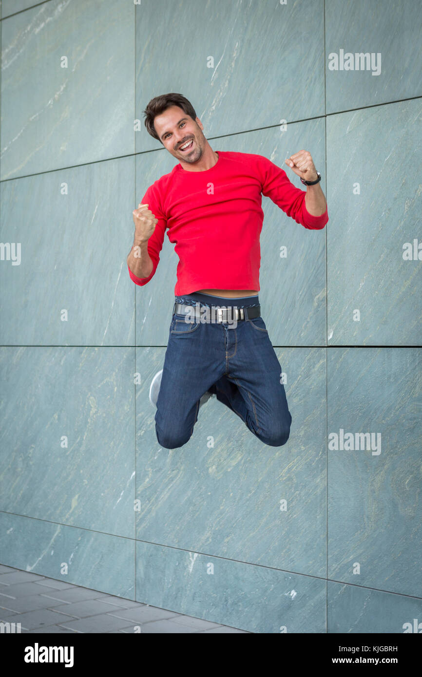 Active man jumping for joy, cheering Stock Photo - Alamy