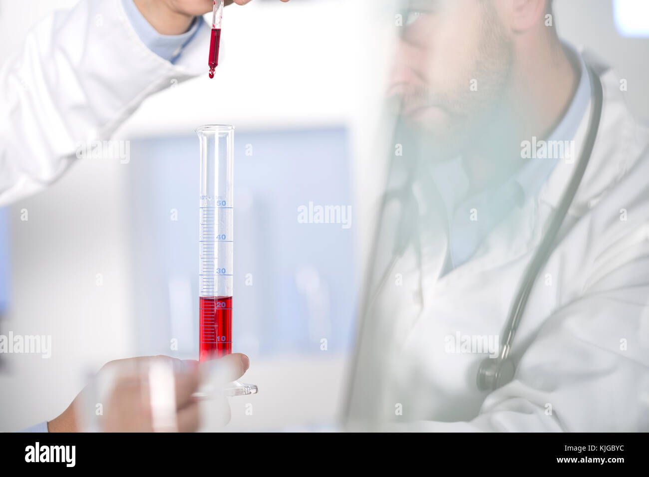 Close-up of lab technician pipetting Stock Photo - Alamy
