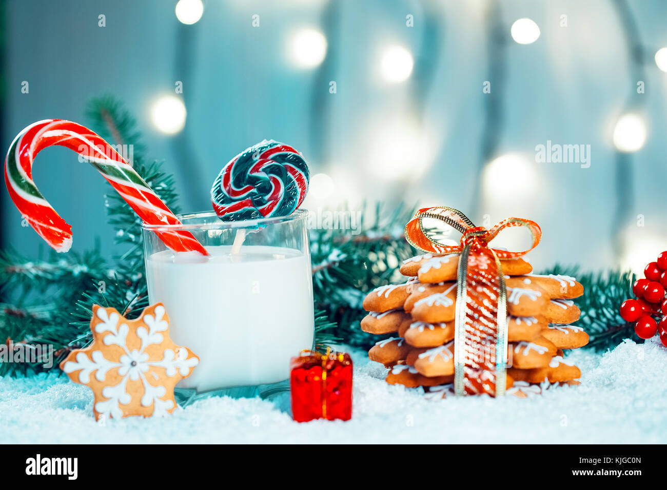 Christmas gingerbread and milk with decorations, snow, christmas tree ...
