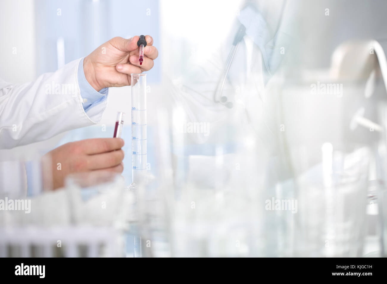 Close-up of lab technician pipetting Stock Photo - Alamy