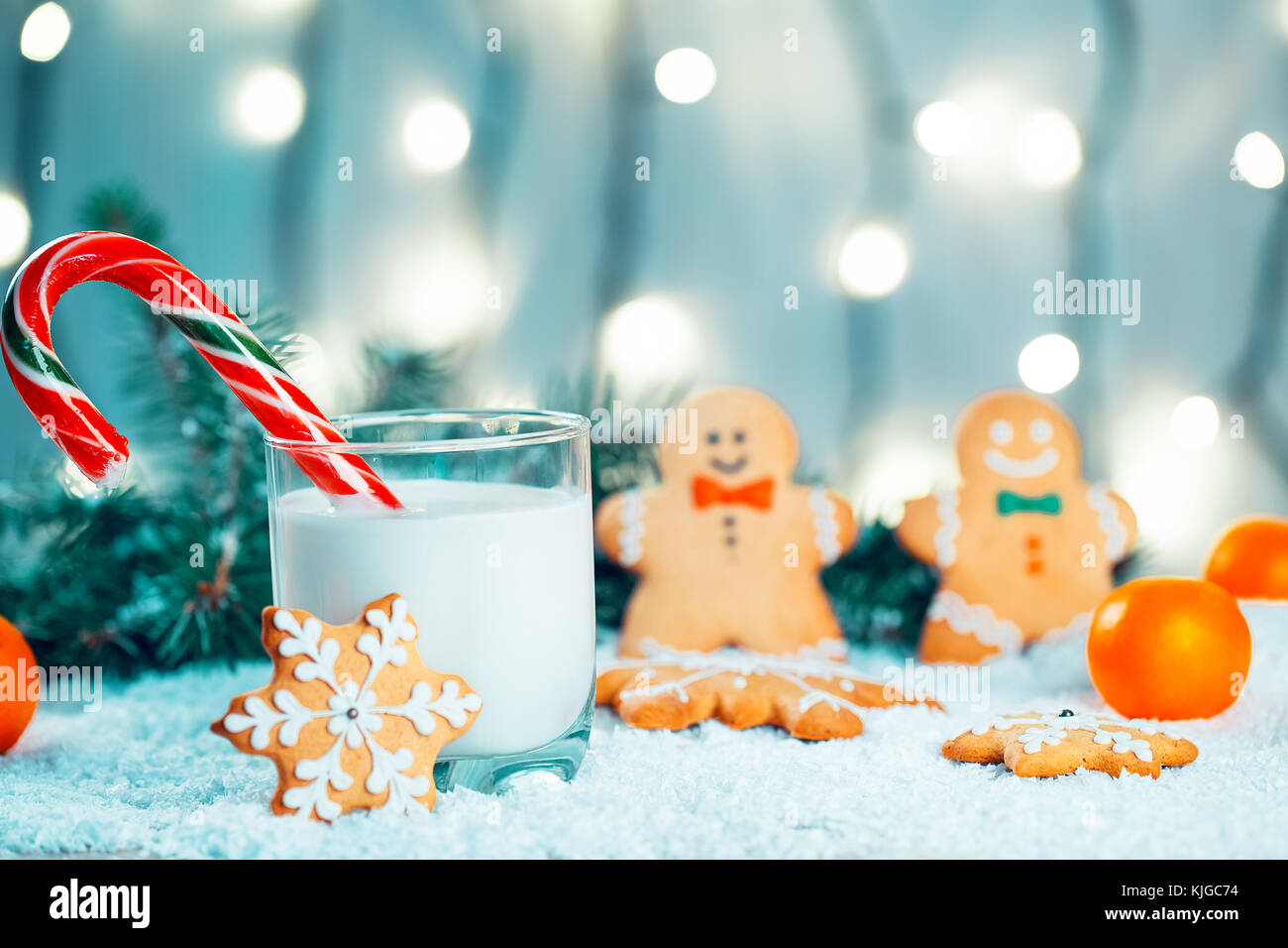 Christmas gingerbread and milk with decorations, snow, christmas tree ...