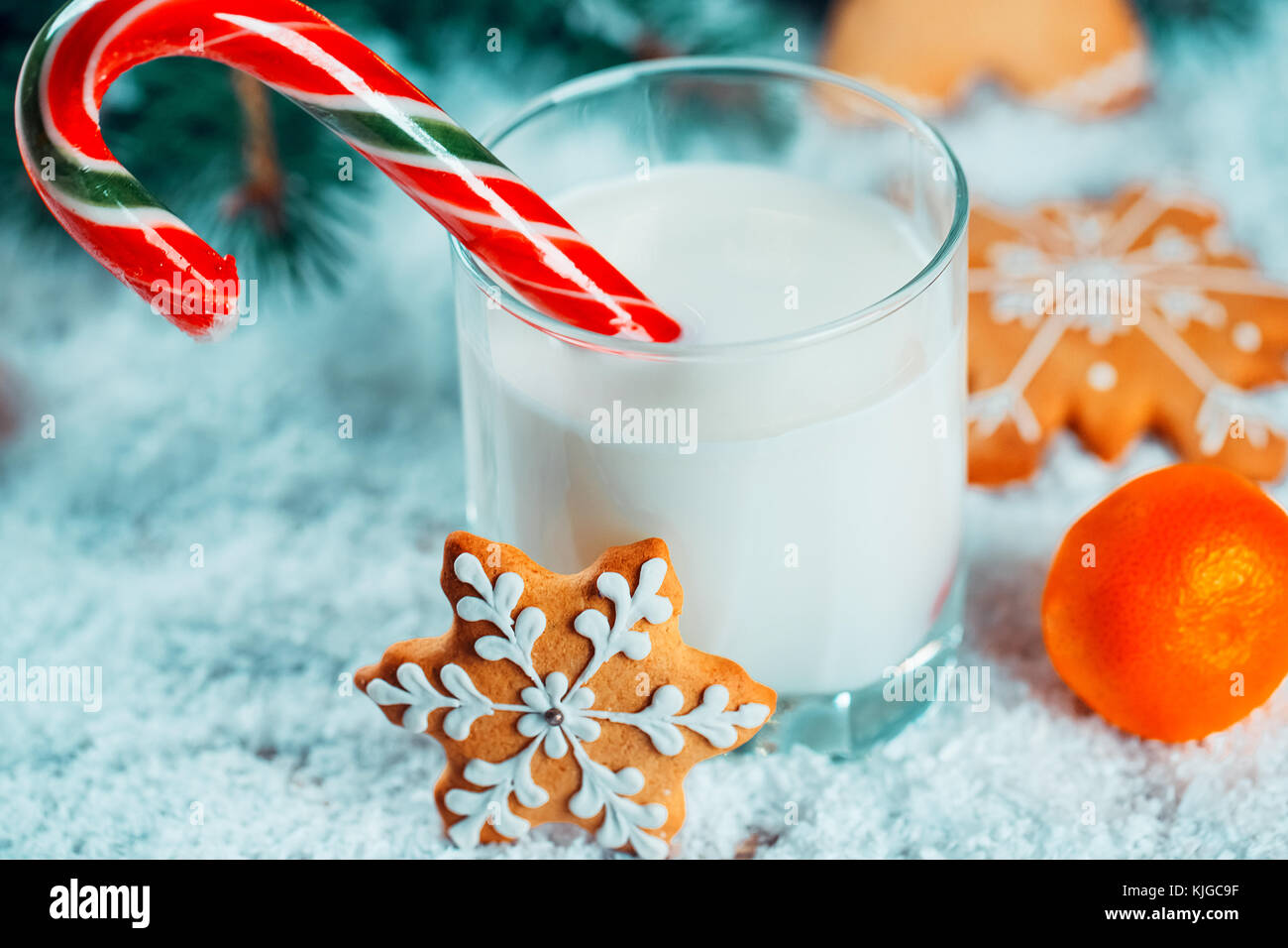 Christmas gingerbread and milk with decorations, snow, christmas tree ...