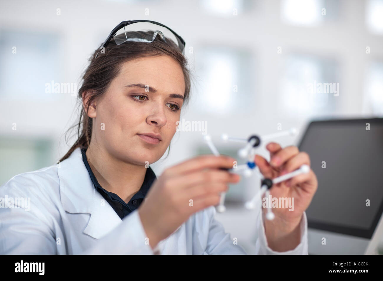 Scientist working in lab holding molecular structure Stock Photo - Alamy