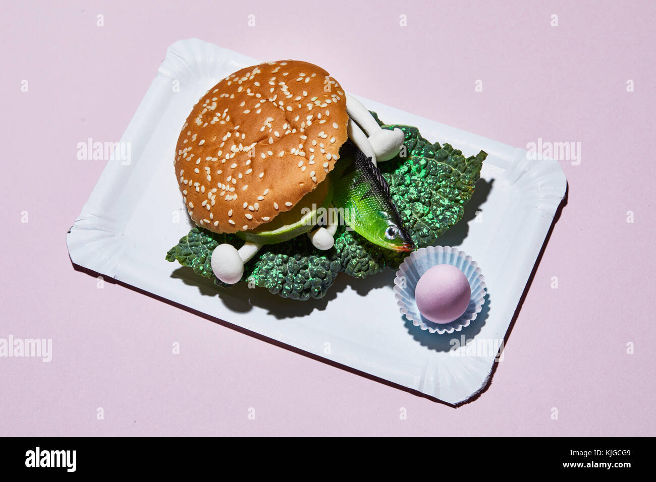 Hamburger with toy fish on paper plate Stock Photo - Alamy
