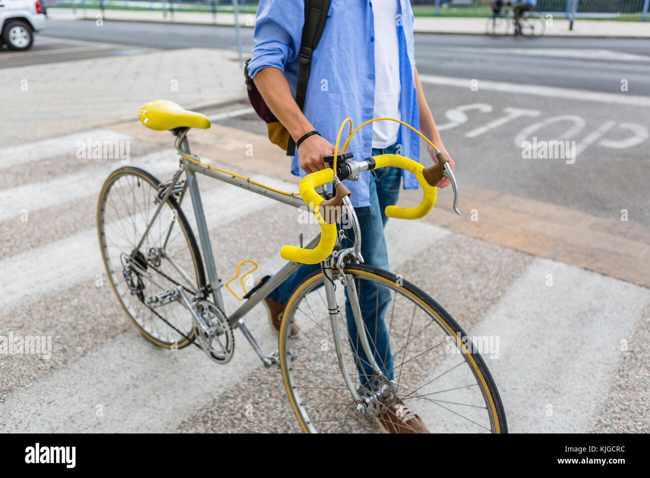 Young man pushing his bike on zebra crossing hi-res stock photography ...