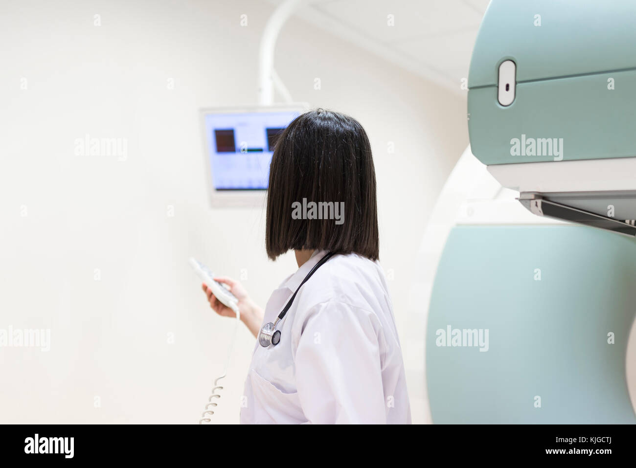 Doctor using remote control Stock Photo - Alamy
