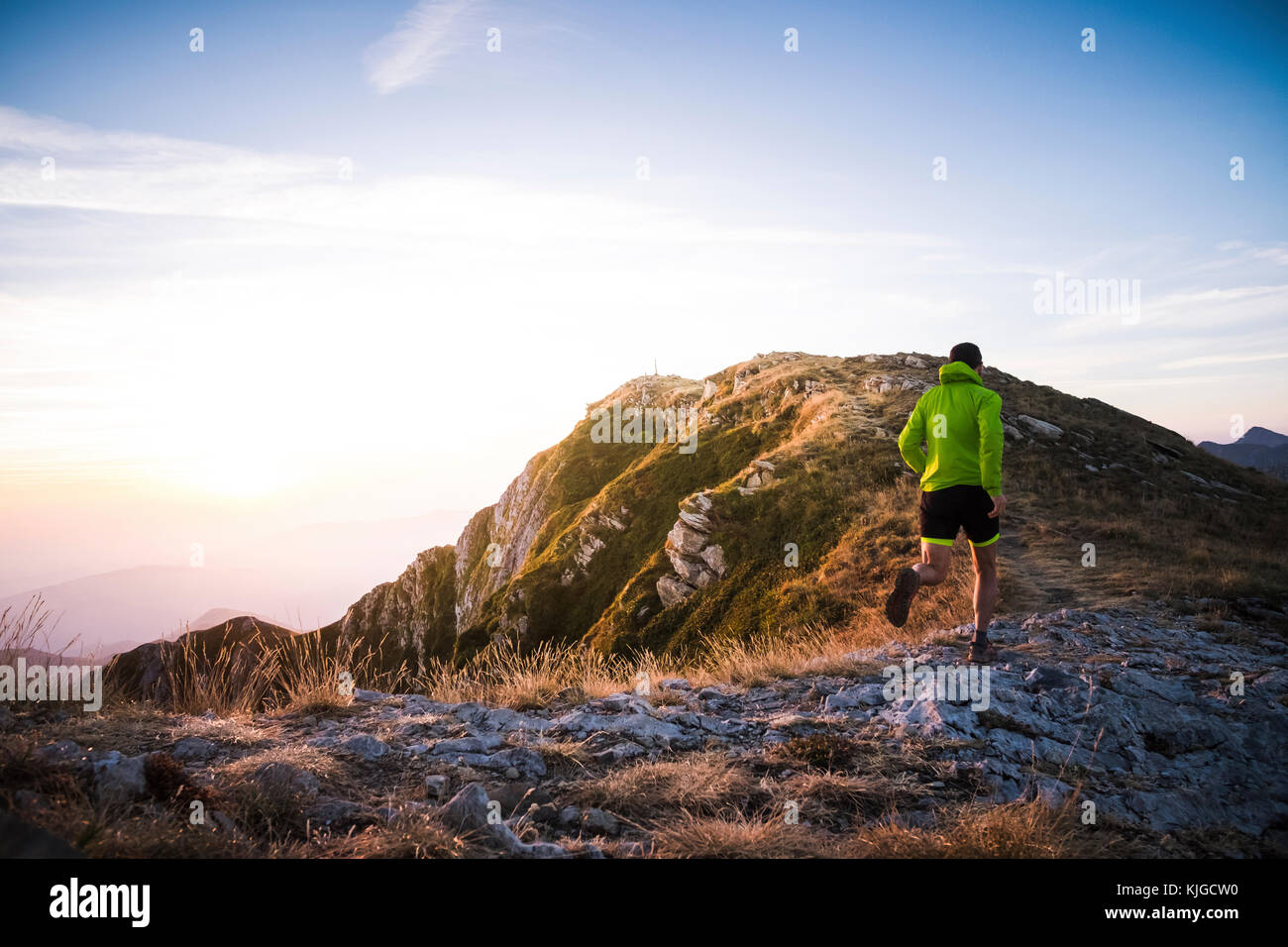 Italy, man running on mountain trail Stock Photo - Alamy