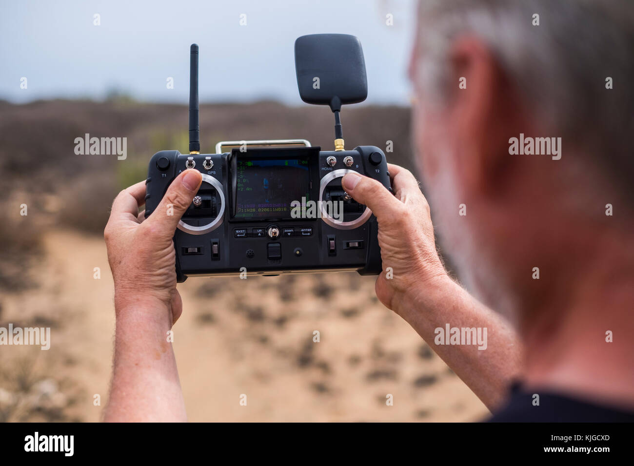 Senior man using telecontrol for drone Stock Photo - Alamy