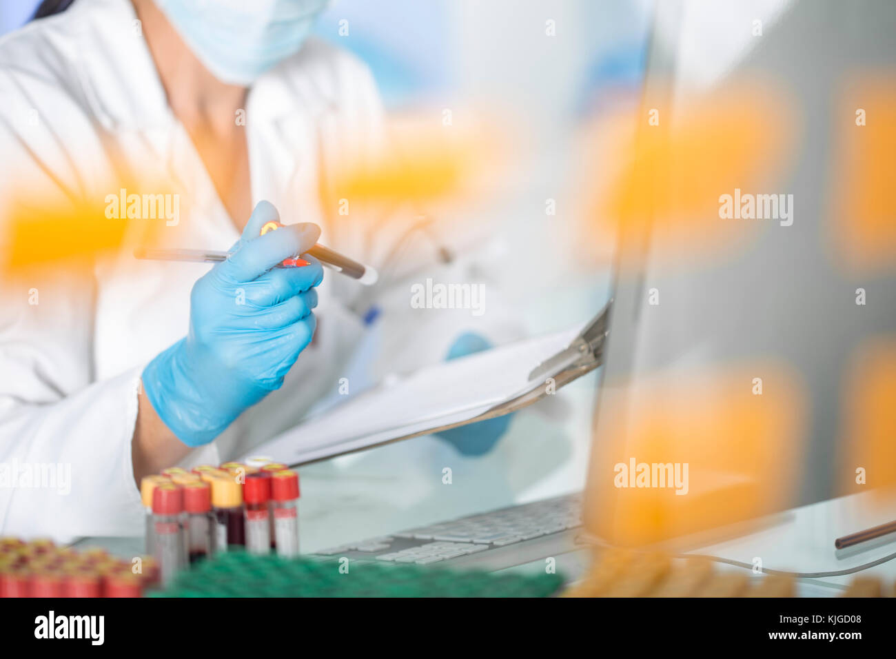 Technician holding and examining test tubes hi-res stock photography ...
