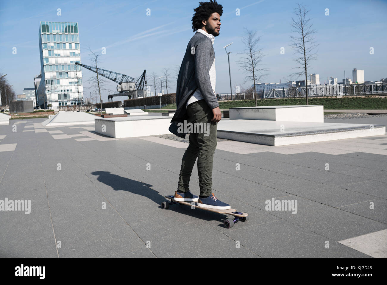 Young man riding longboard in skatepark Stock Photo - Alamy
