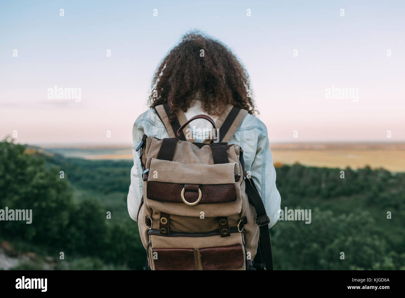Back view of teenage girl with backpack in nature Stock Photo - Alamy