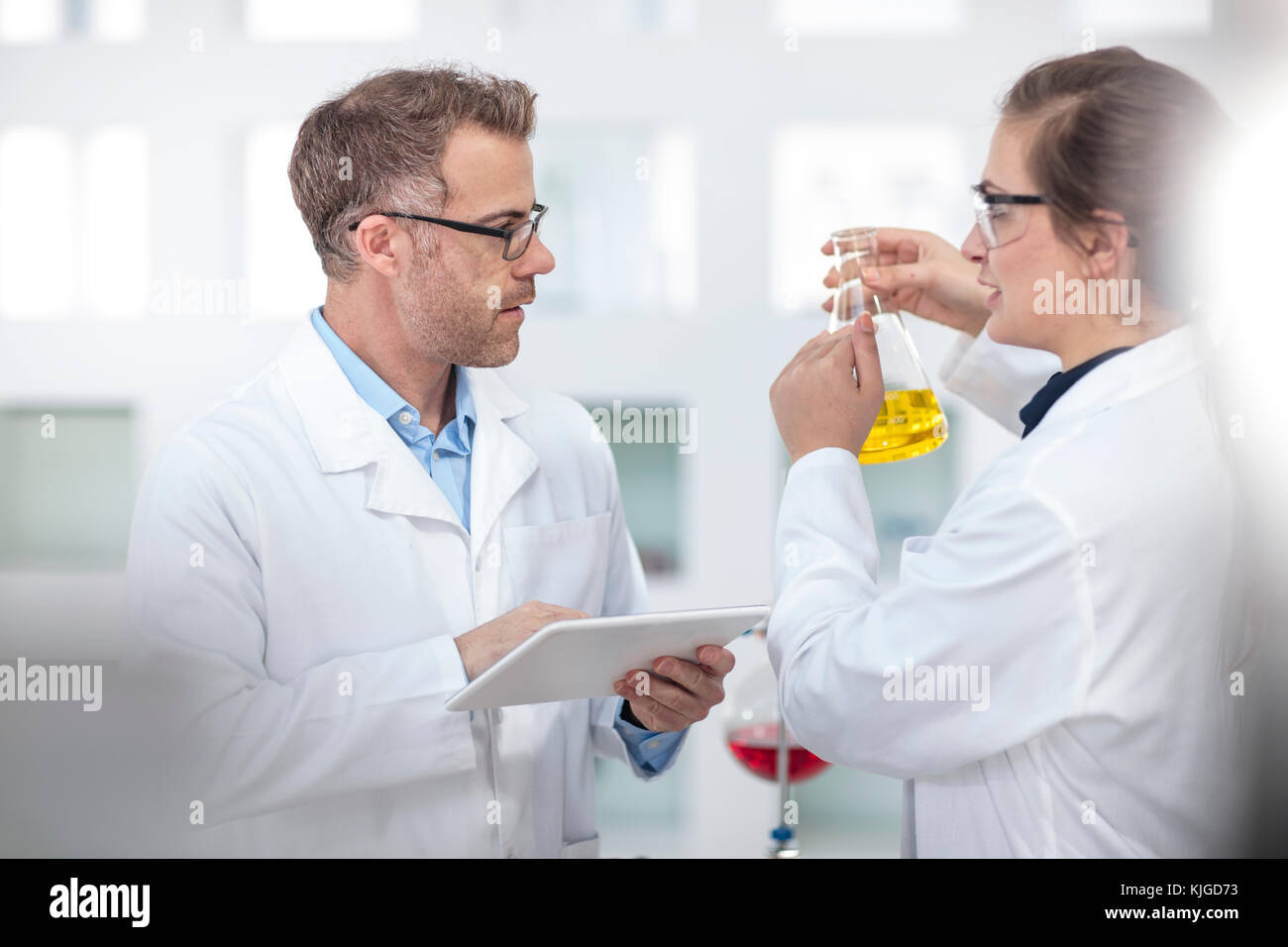 Scientists in lab looking beaker hi-res stock photography and images - Alamy